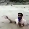 Viral Video Of Pakistani journalist gets into flooded river for report